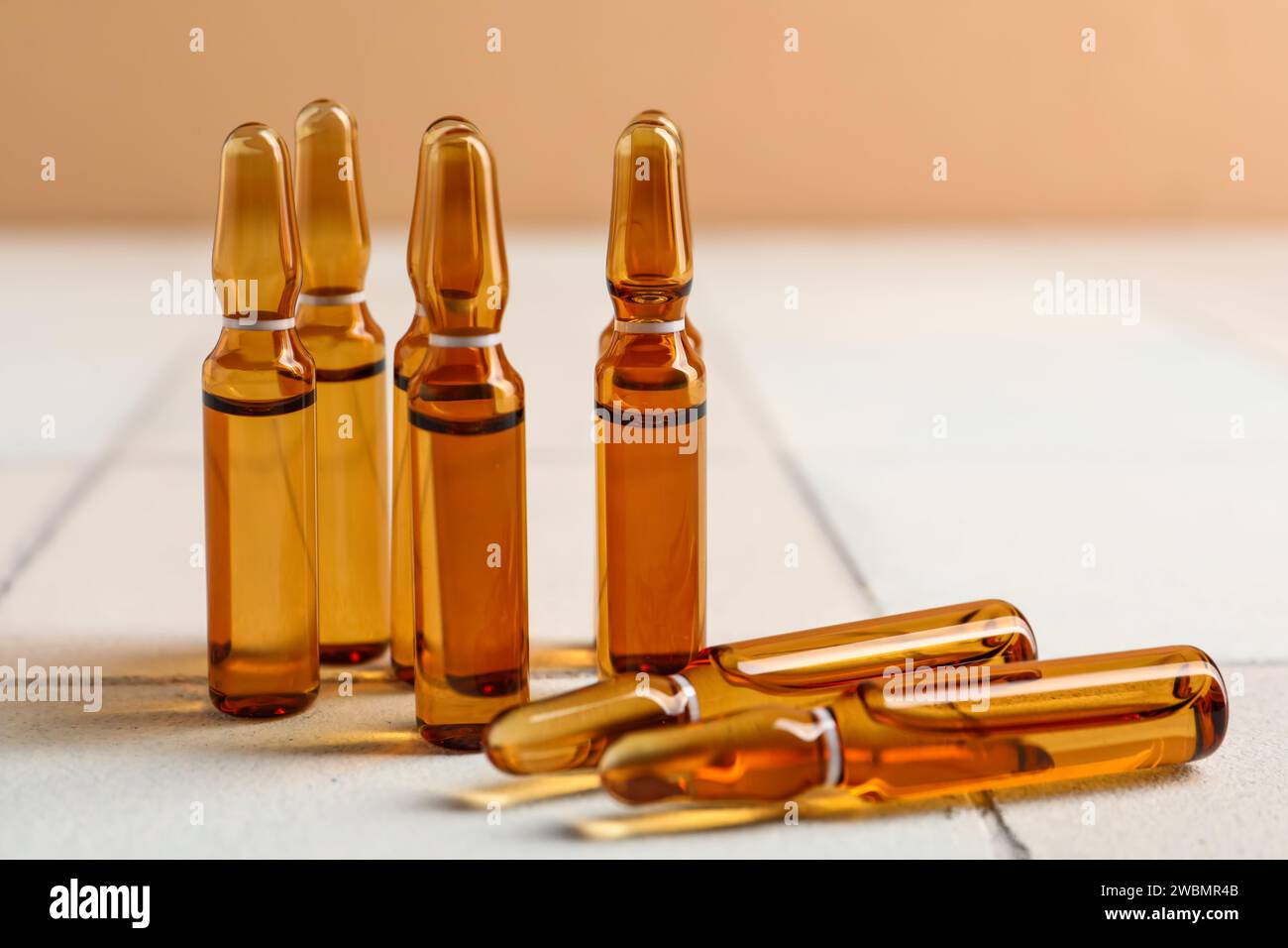Medical ampules on white tile table Stock Photo - Alamy