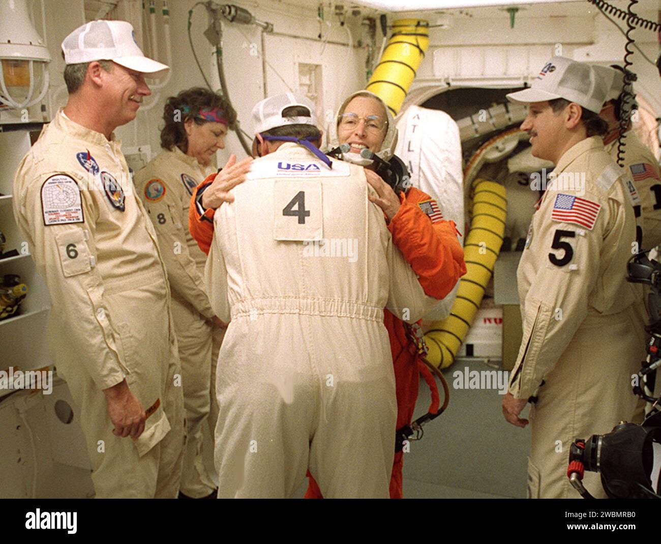 In the White Room before launch, STS-98 Mission Specialist Marsha Ivins gets a hug from a ...