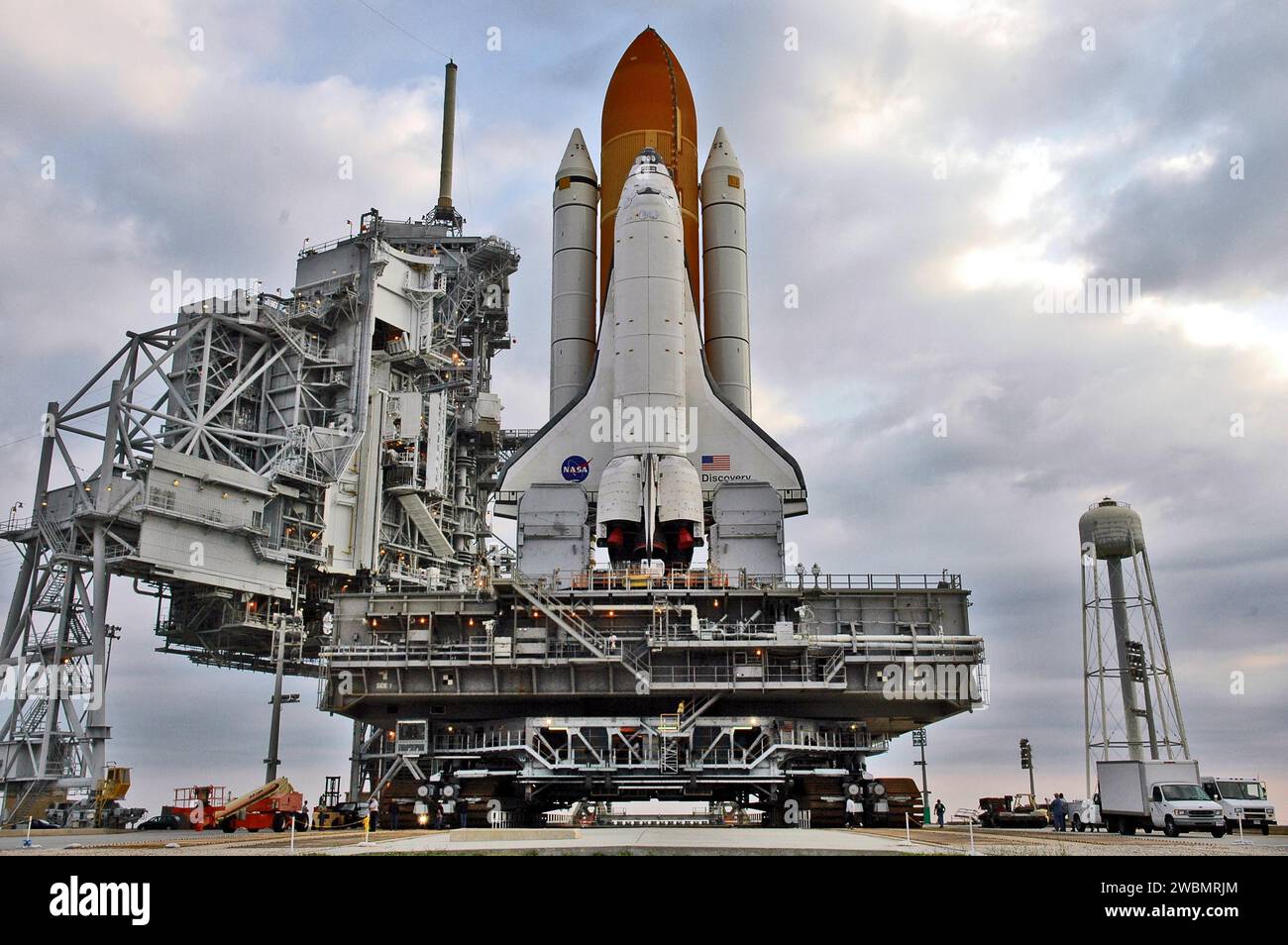 KENNEDY SPACE CENTER, FLA. - Under post-dawn cloudy skies, Space Shuttle Discovery, resting on ...