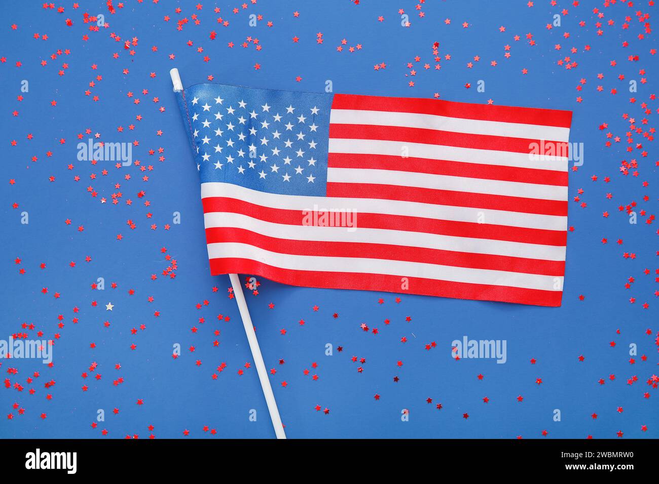 USA flag and confetti on blue background. Independence Day celebration ...