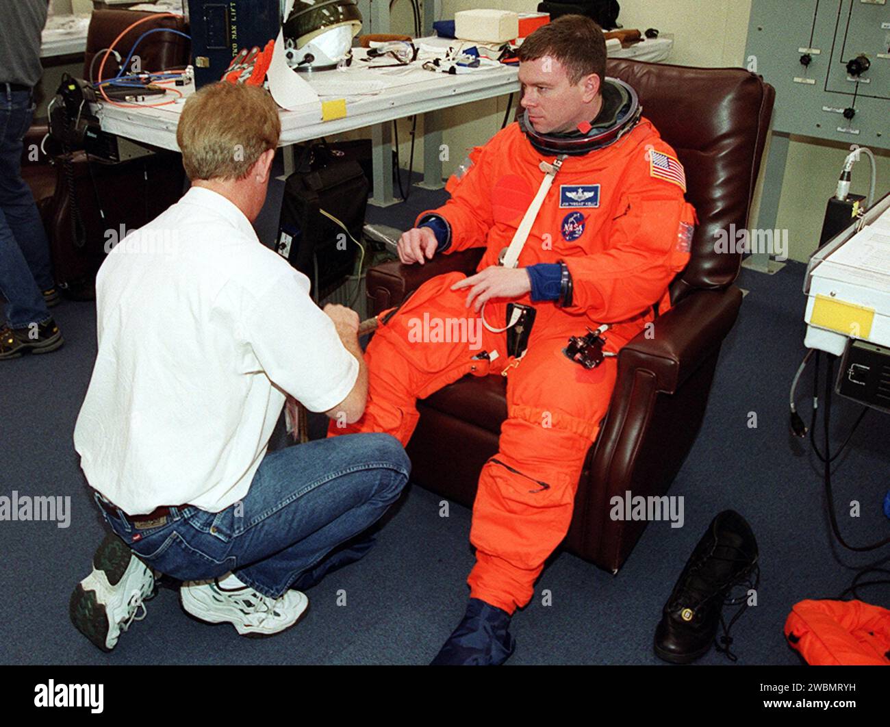 STS-102 Pilot James Kelly has his launch suit checked during suit fit in the Operations and ...