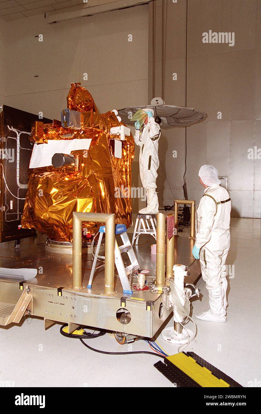 Workers in the Space Assembly and Encapsulation Building 2 prepare the ...