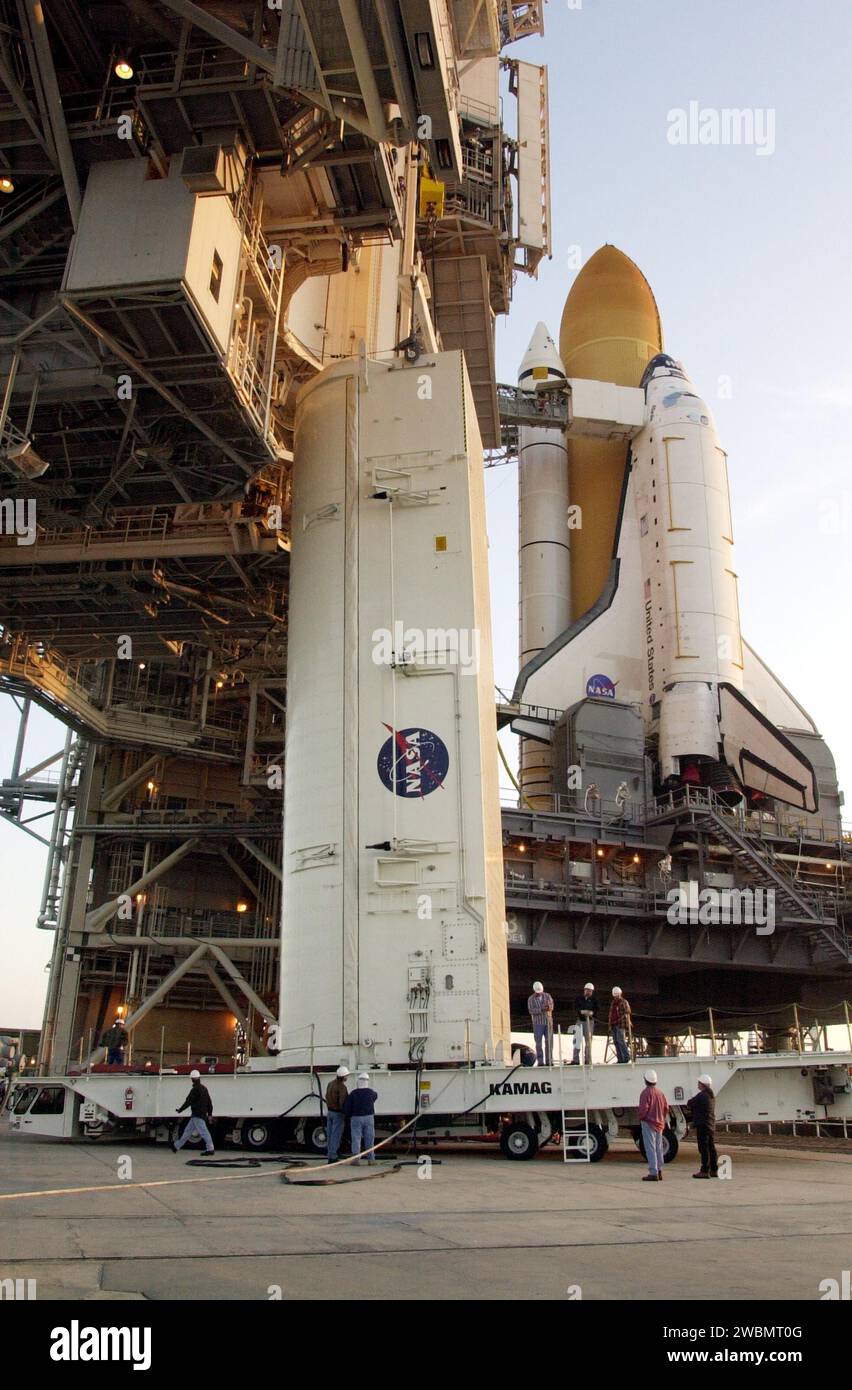 KENNEDY SPACE CENTER, FLA. - On the launch pad, workers prepare the payload canister for its ...