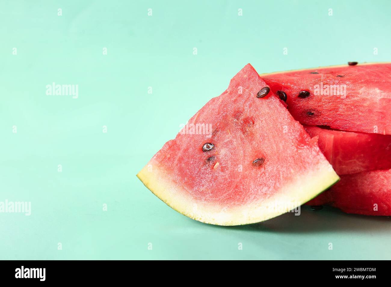 Pieces of fresh watermelon on turquoise background Stock Photo - Alamy