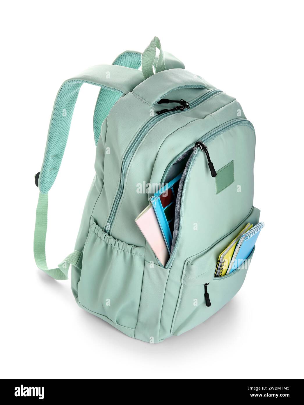 Stylish blue school backpack with different stationery supplies on ...