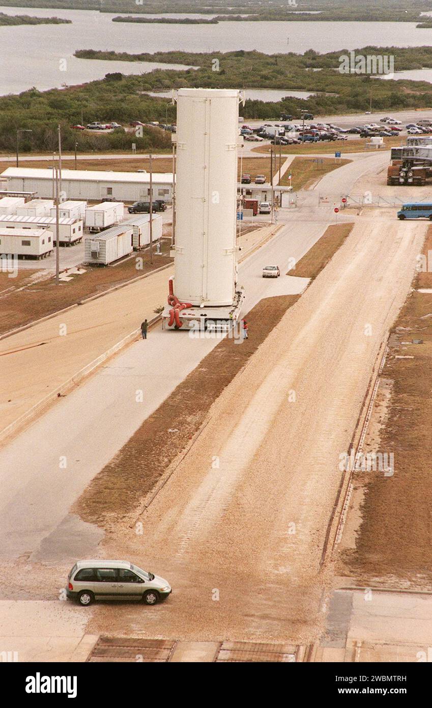 An empty payload canister is transported along the crawlerway to Launch ...