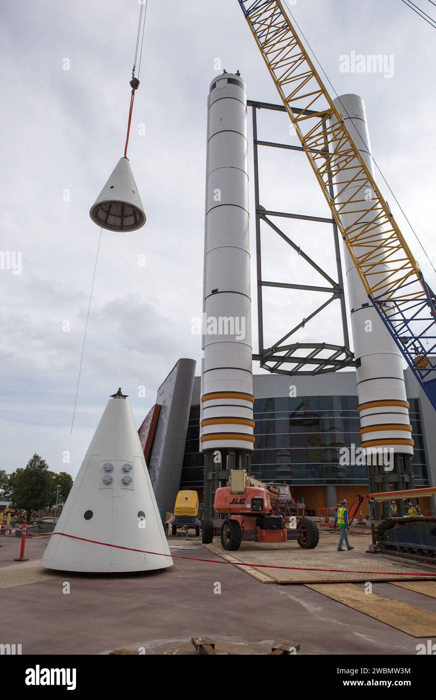 CAPE CANAVERAL, Fla. – A crane lifts a nose cone to top out one of a pair of replica space ...