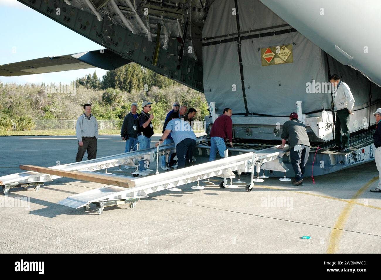 KENNEDY SPACE CENTER, FLA. - At KSC’s Shuttle Landing Facility, workers ...