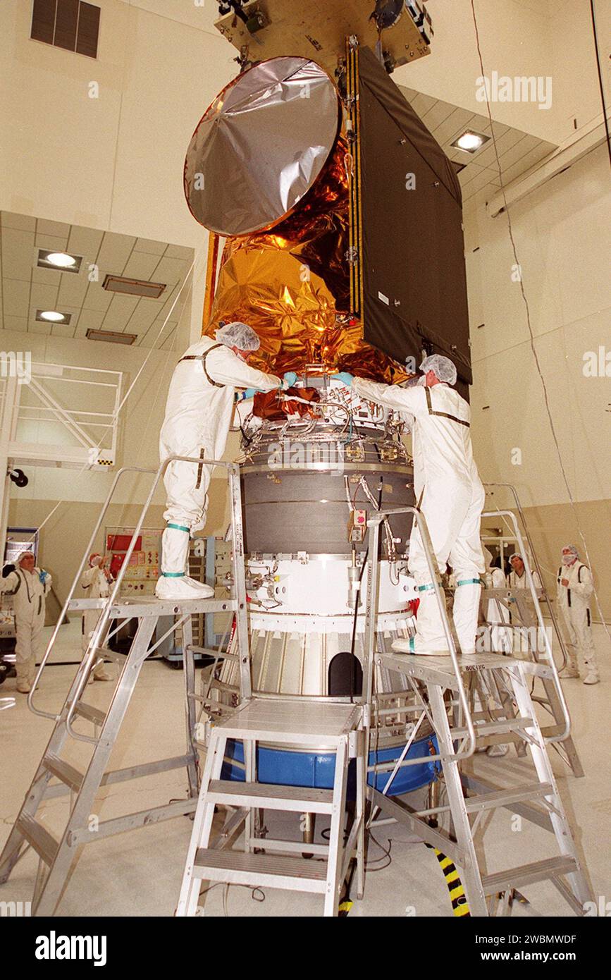 Workers in the Space Assembly and Encapsulation Facility 2 check the ...