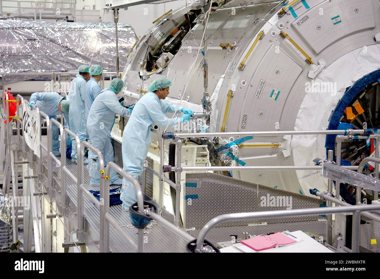 KENNEDY SPACE CENTER, FLA. - Technicians in the Space Station ...