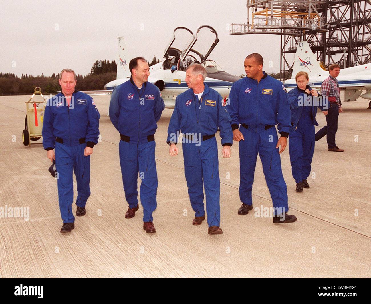 KENNEDY SPACE CENTER, FLA. -- The STS-98 crew crosses the parking apron ...