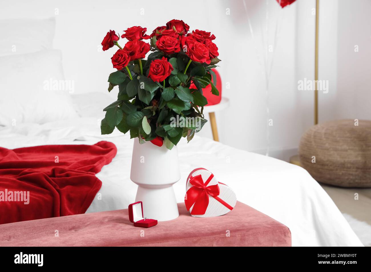 Bouquet of roses, box with engagement ring and heart-shaped gift box on ...