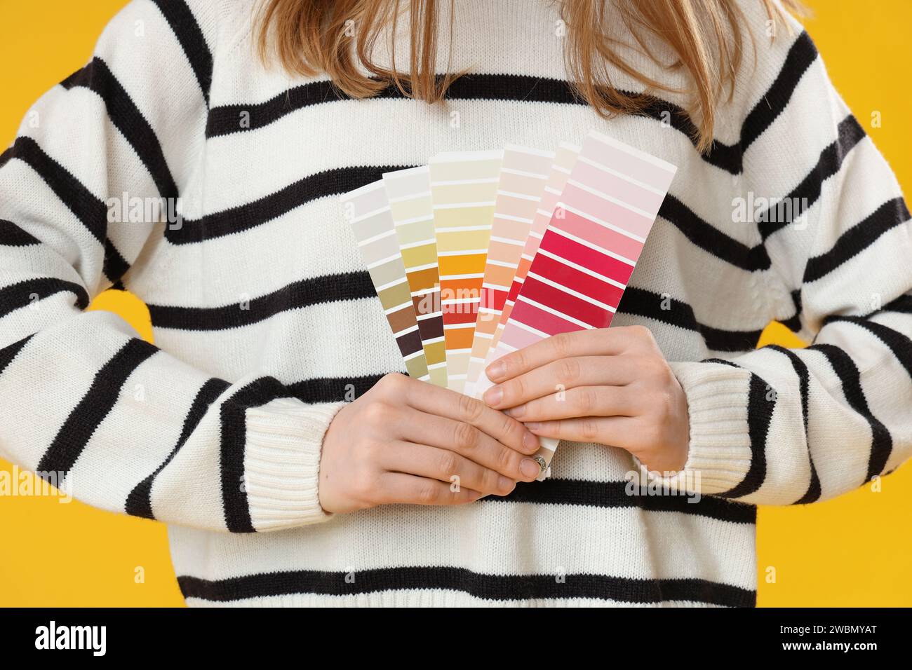 Woman with color palettes on yellow background, closeup Stock Photo - Alamy