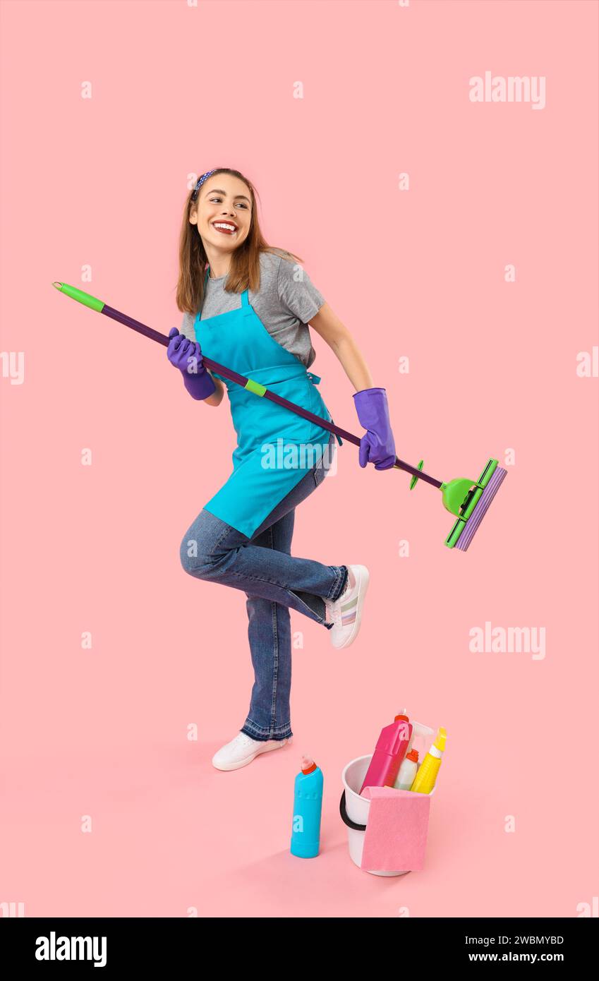 Pretty woman with mop and cleaning supplies on pink background Stock ...