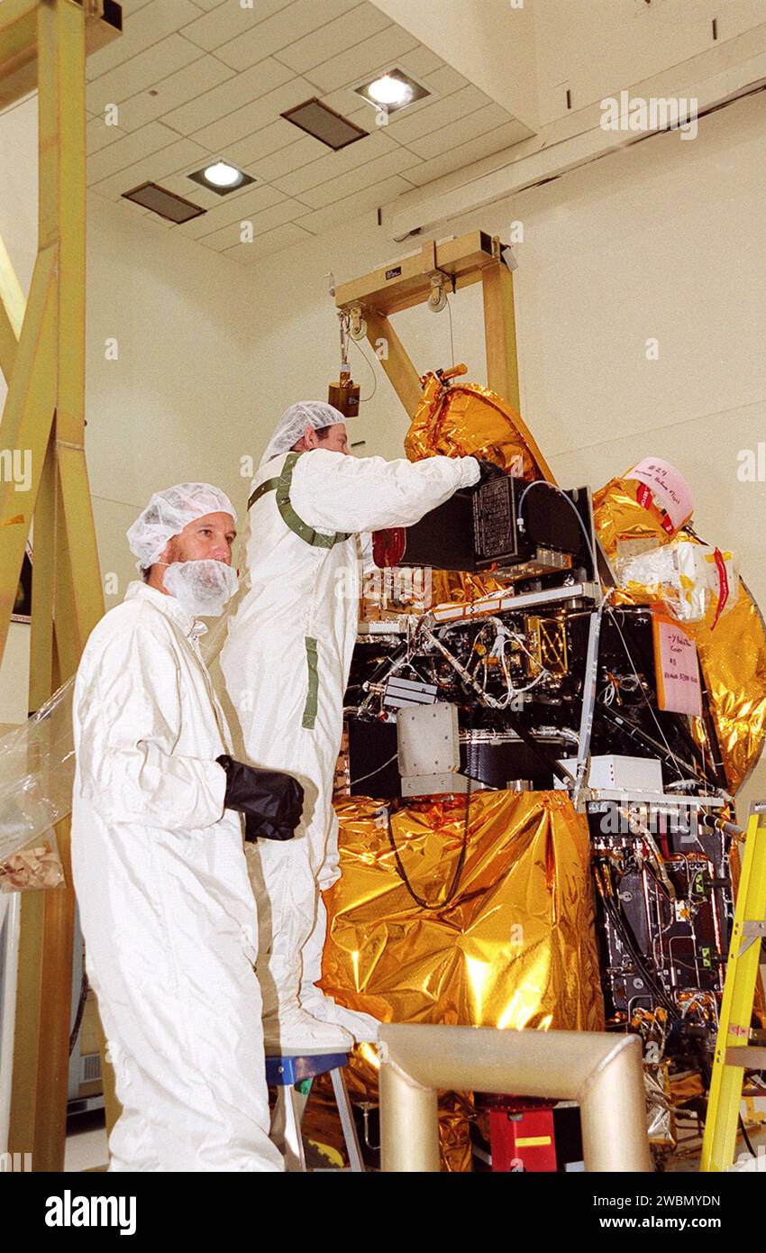 Workers in the Spacecraft Assembly and Encapsulation Facility 2 adjust ...