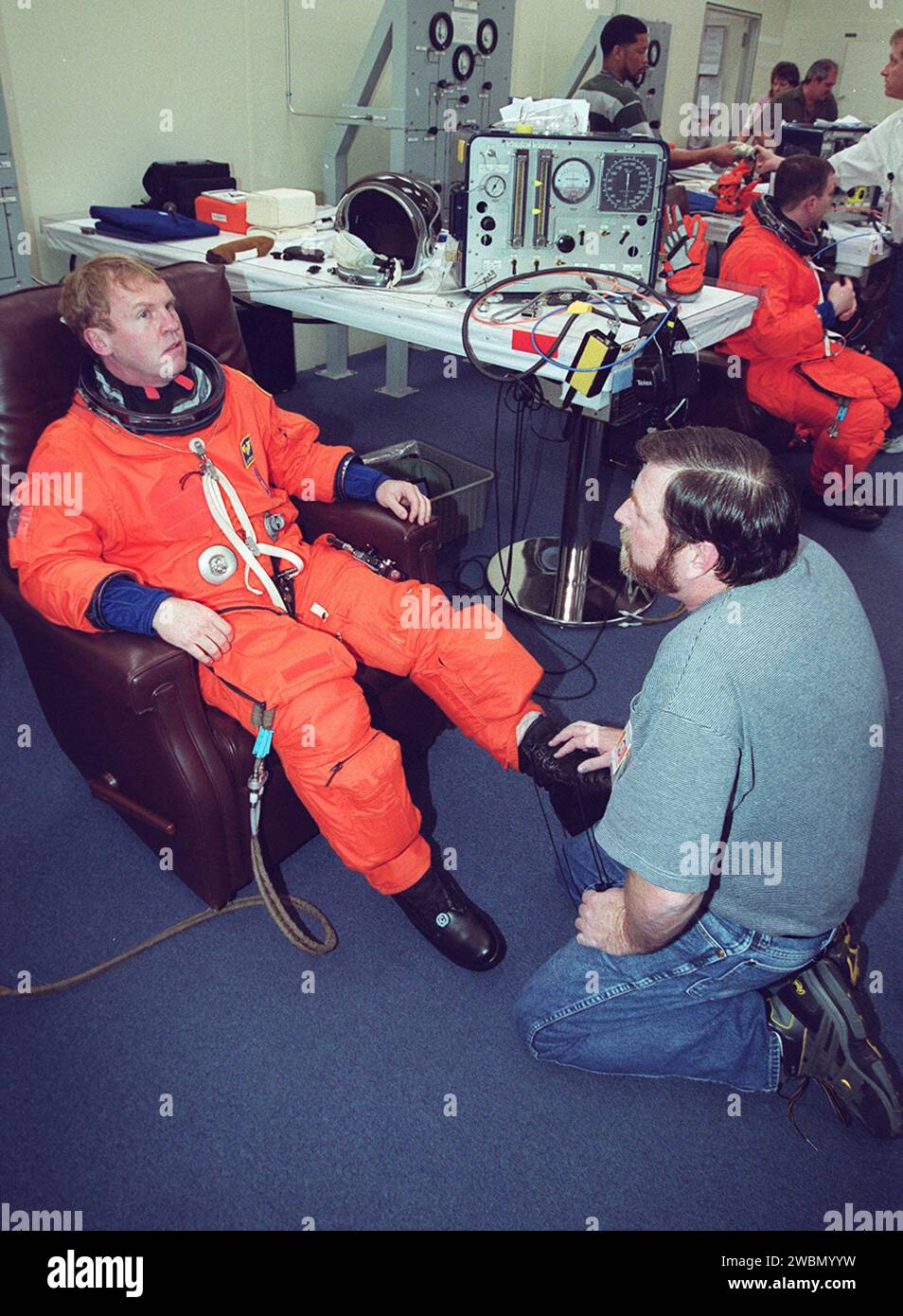 STS-102 Mission Specialist Andrew Thomas has his launch suit checked ...