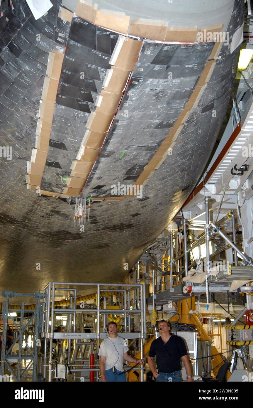 Technicians from United Space Alliance retract and inspect the nose ...