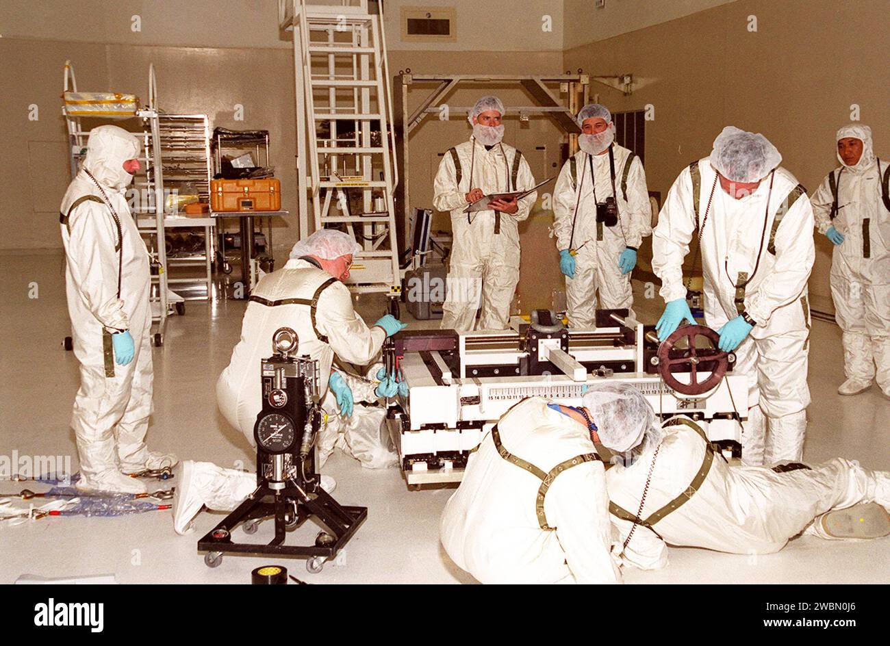 Workers in the Space Assembly and Encapsulation Building 2 prepare the ...