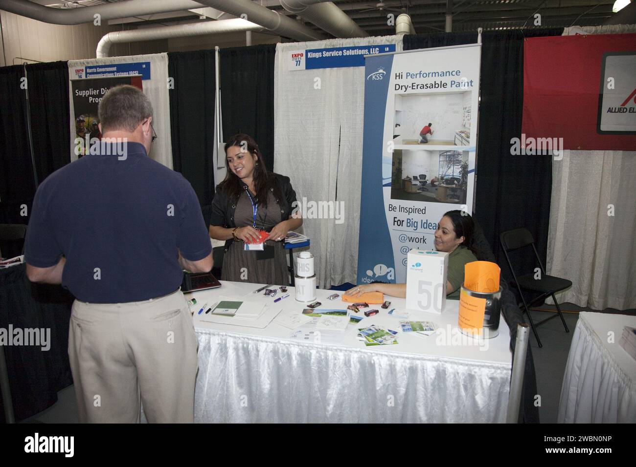 CAPE CANAVERAL, Fla. – A business leader visits an exhibitor booth at ...