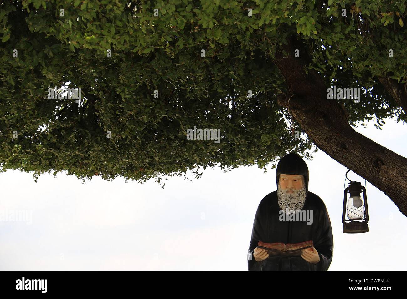 A statue of the Lebanese Saint Mar Charbel reading the bible Stock ...