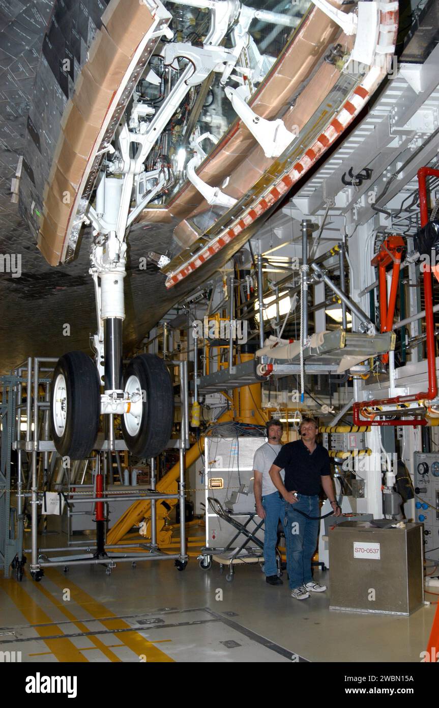 Technicians at Kennedy Space Center retract and test the nose landing ...
