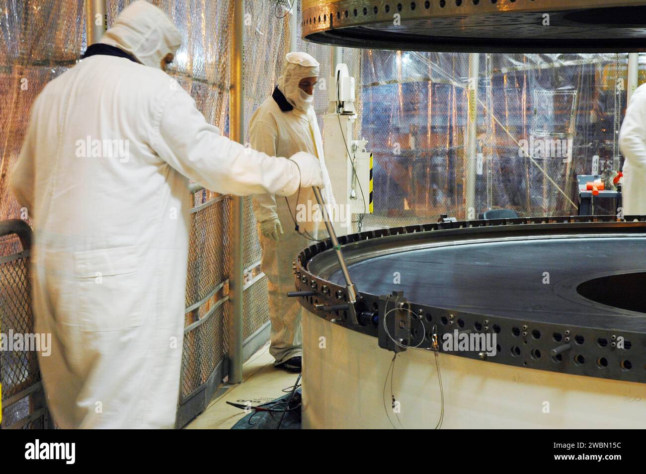 Workers in the VAB align the aft center segment of a Solid Rocket ...