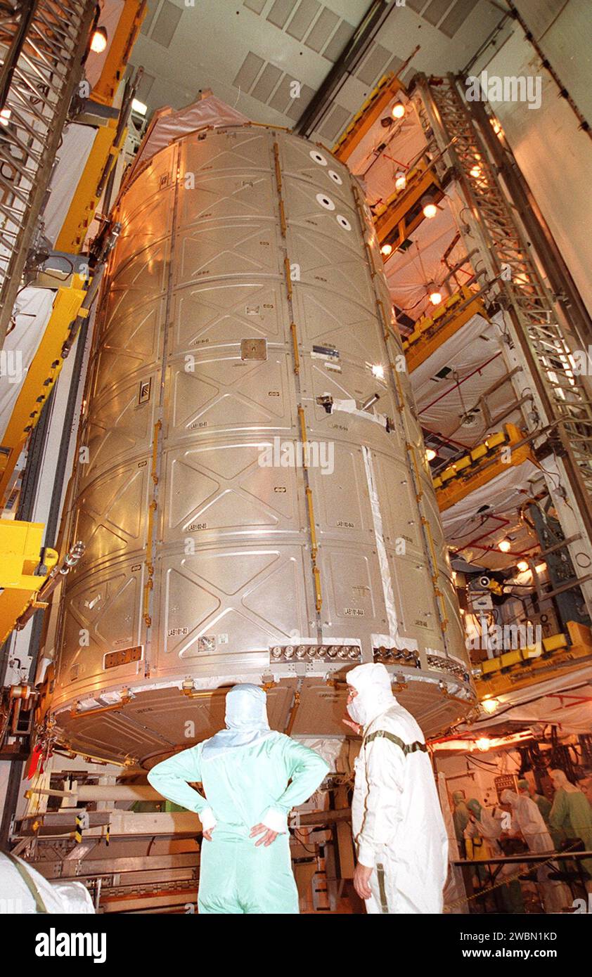 Workers in the Payload Changeout Room check the U.S. Lab Destiny as its moves from Atlantis ...