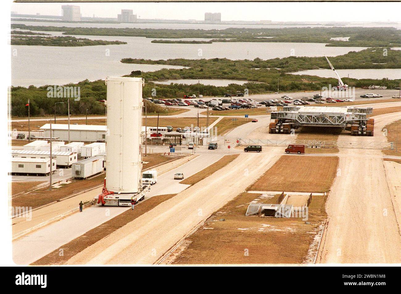 At Kennedy Space Center, an empty payload canister is transported ...