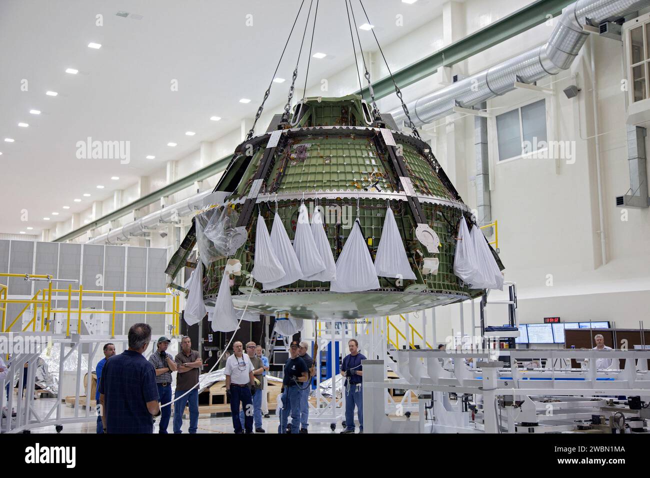 Technicians move the Exploration Flight Test-1 (EFT-1) Orion crew ... Technicians move the Exploration Flight Test-1 (EFT-1) Orion crew ...