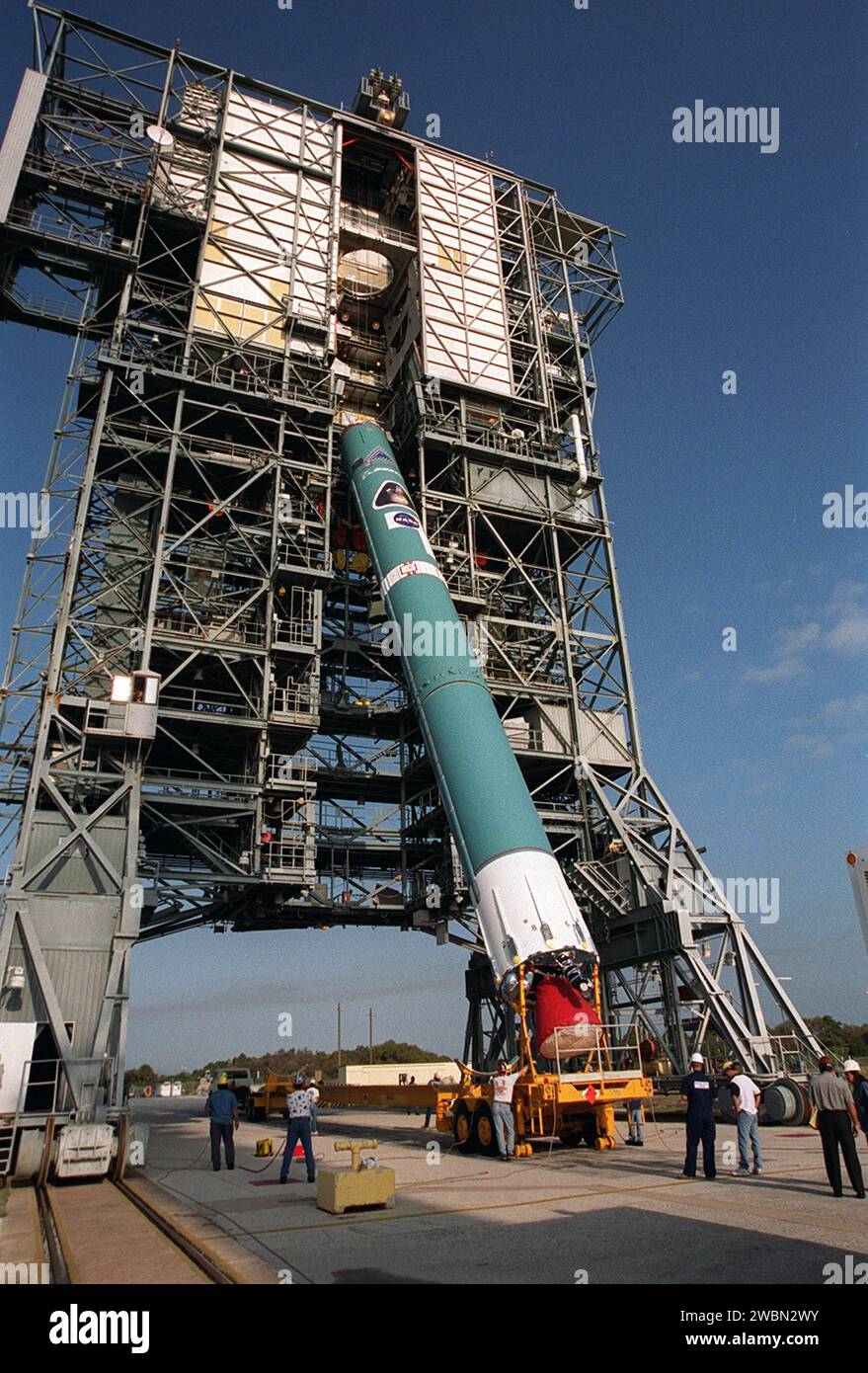 On Launch Pad 17-A, Cape Canaveral Air Force Station, workers maneuver ...