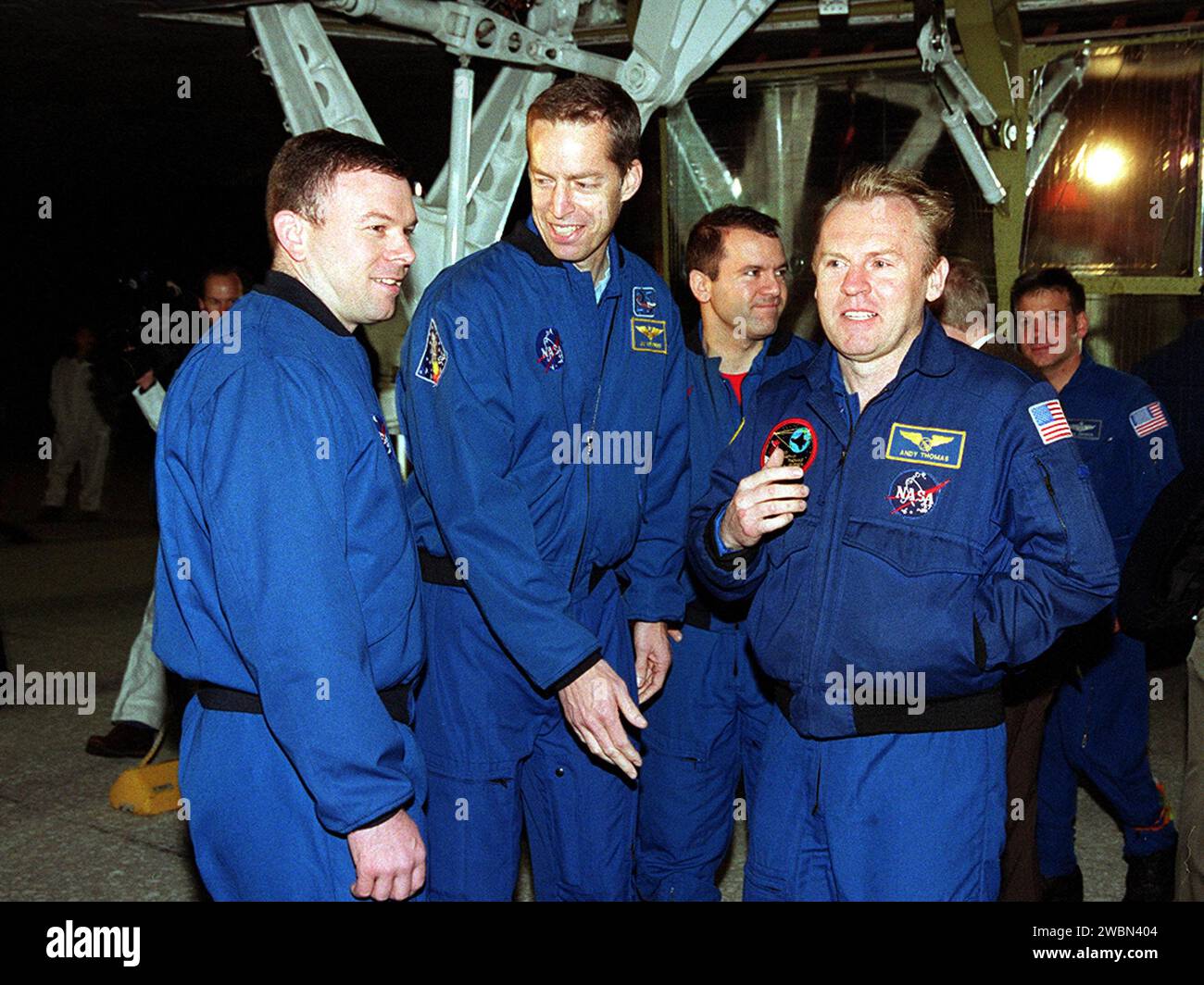 After exiting the Crew Transport Vehicle, the STS-102 crew gathers under Discovery for a walk ...
