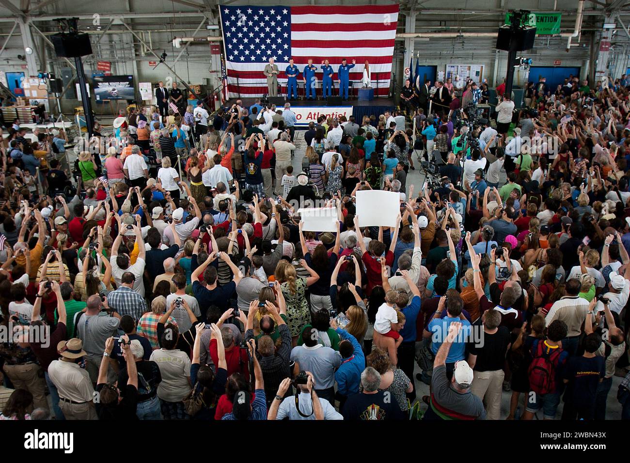 A large crowd of supporters welcomes home the crew of STS-135 during a ...