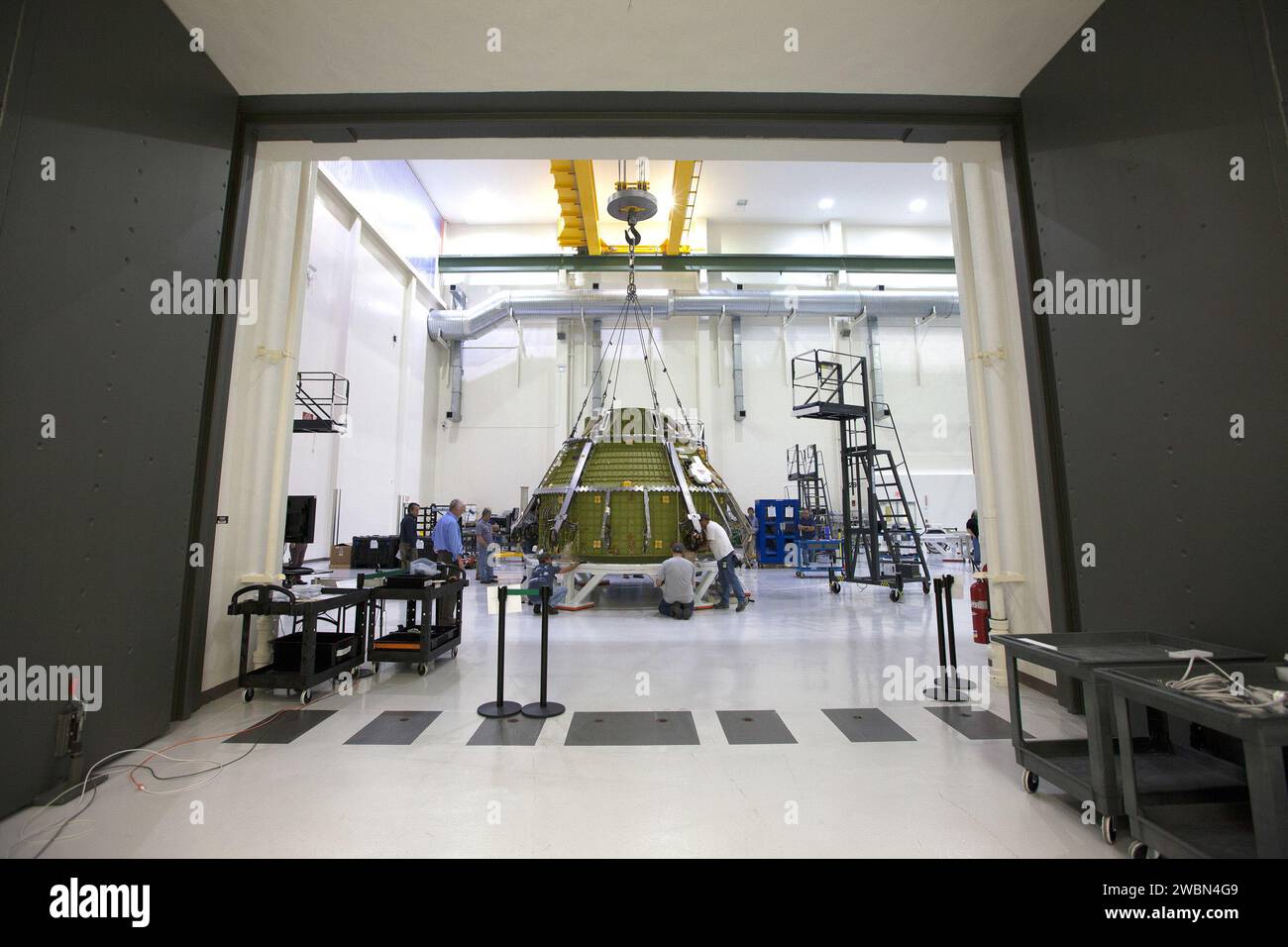 The Orion crew module for Artemis I is lifted into a test stand for ...