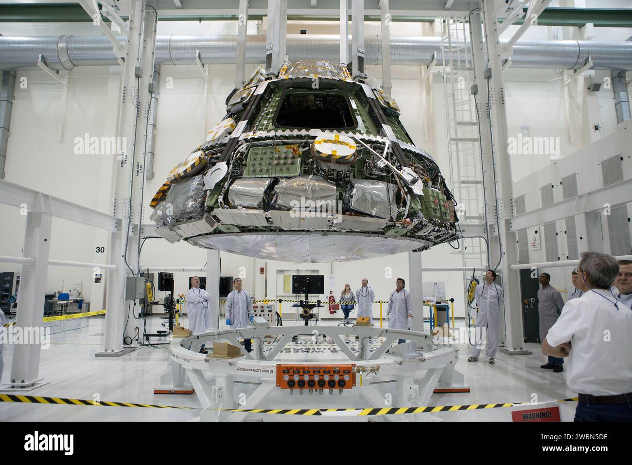 The Orion EFT-1 crew module is prepared for heat shield mating inside ...