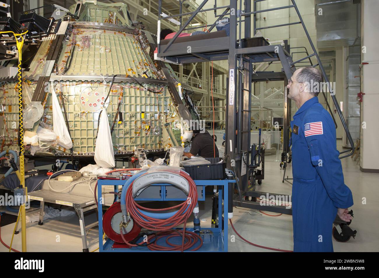 Technicians at Kennedy Space Center work on the Orion crew module in ...