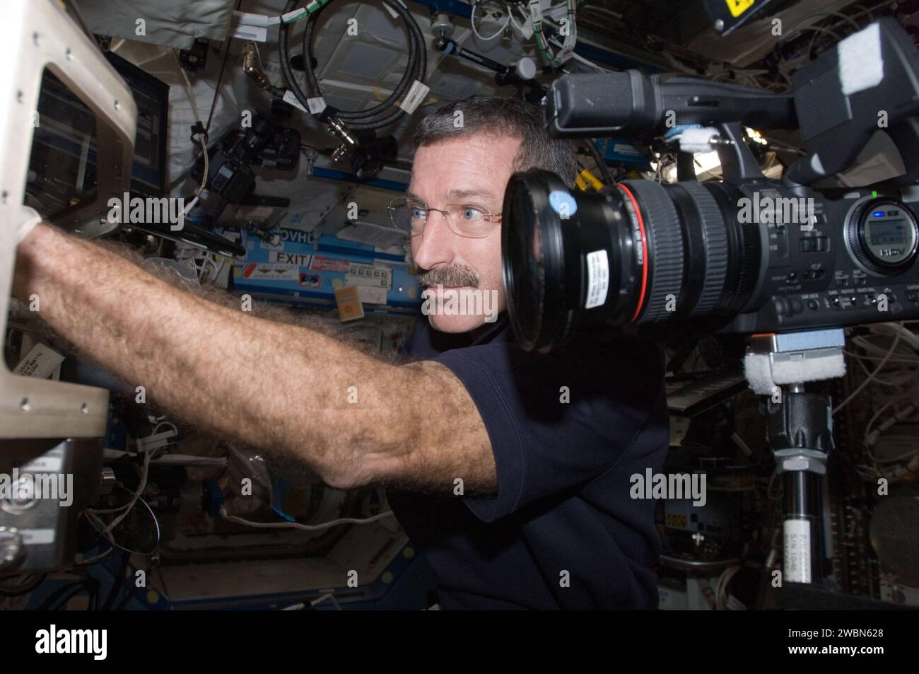 NASA astronaut Dan Burbank, Expedition 30 commander, operates the Light ...