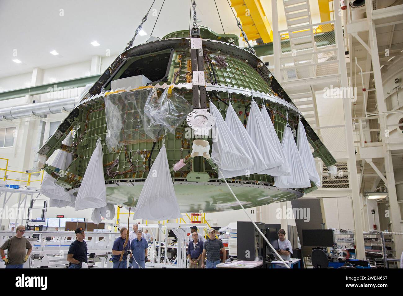 Technicians move the Exploration Flight Test-1 (EFT-1) Orion crew ... Technicians move the Exploration Flight Test-1 (EFT-1) Orion crew ...