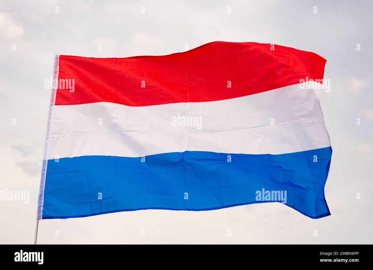 Dutch national flag on liberty day against blue sky with clouds Stock ...
