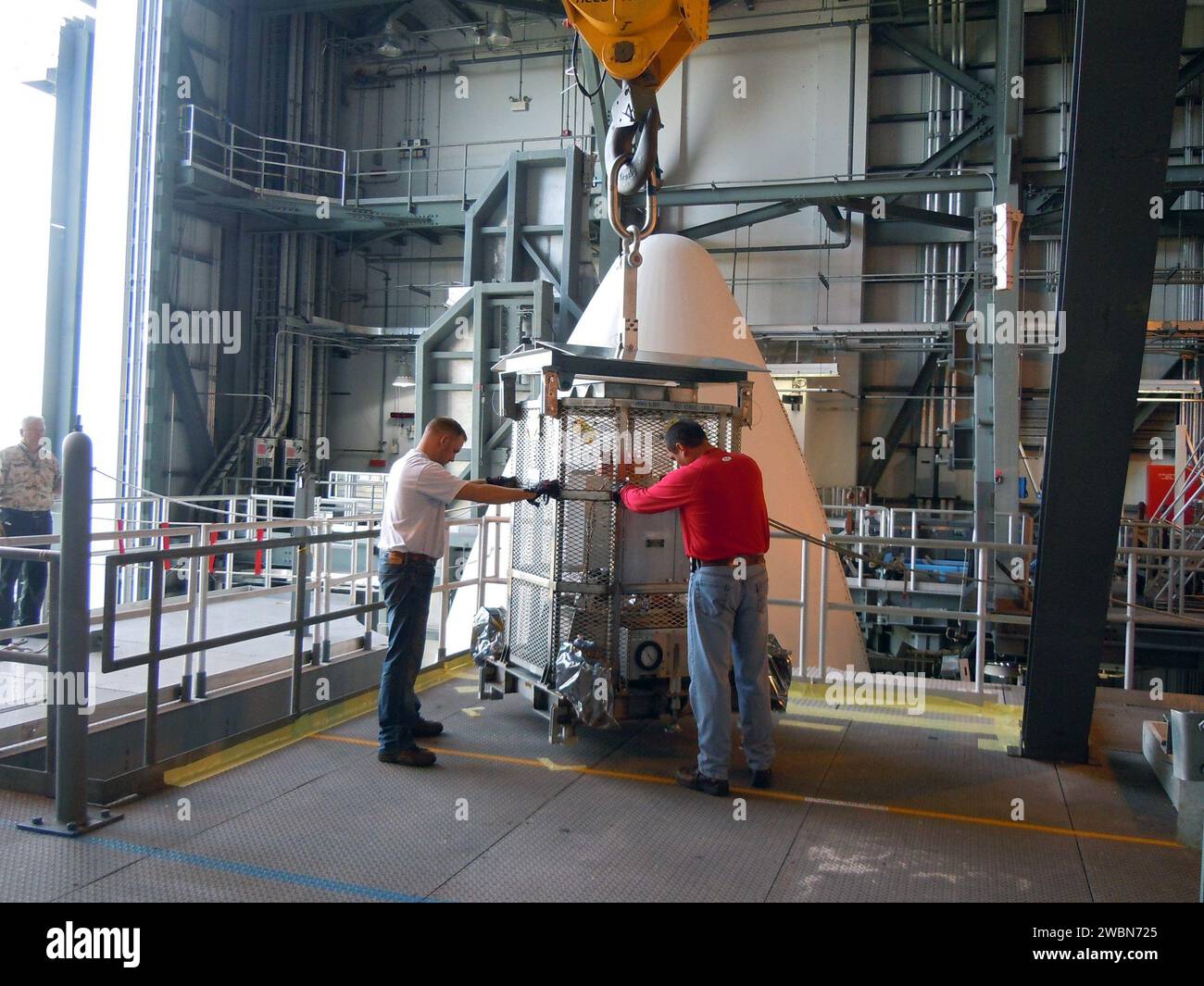 Technicians at Cape Canaveral prepare to install the MMRTG on NASA's ...
