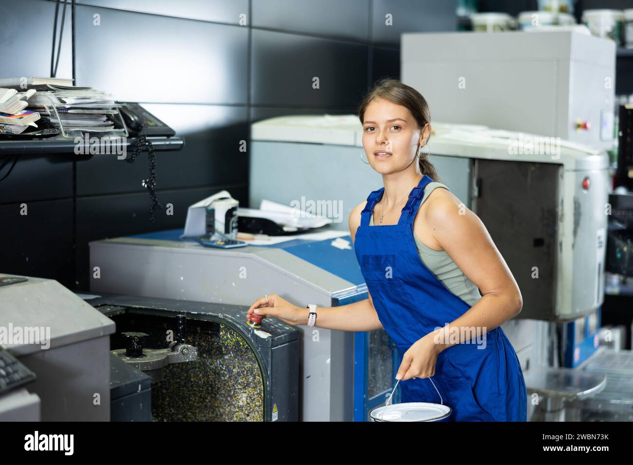 Hardware store employee combining just the right tints of paint in an ...