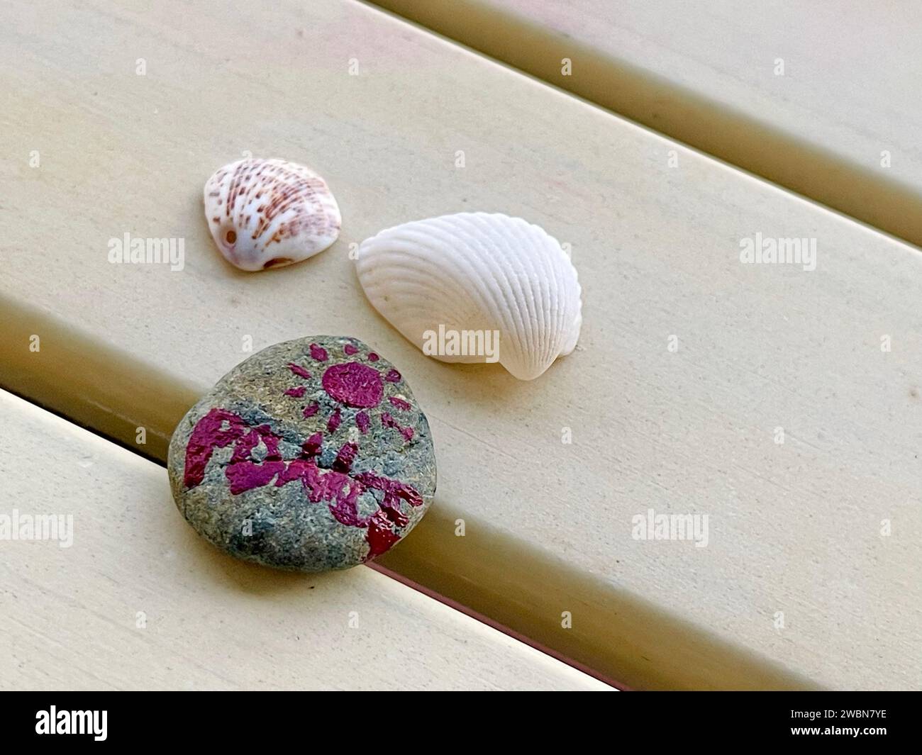 A rustic piece of wood featuring a beautiful arrangement of rocks ...