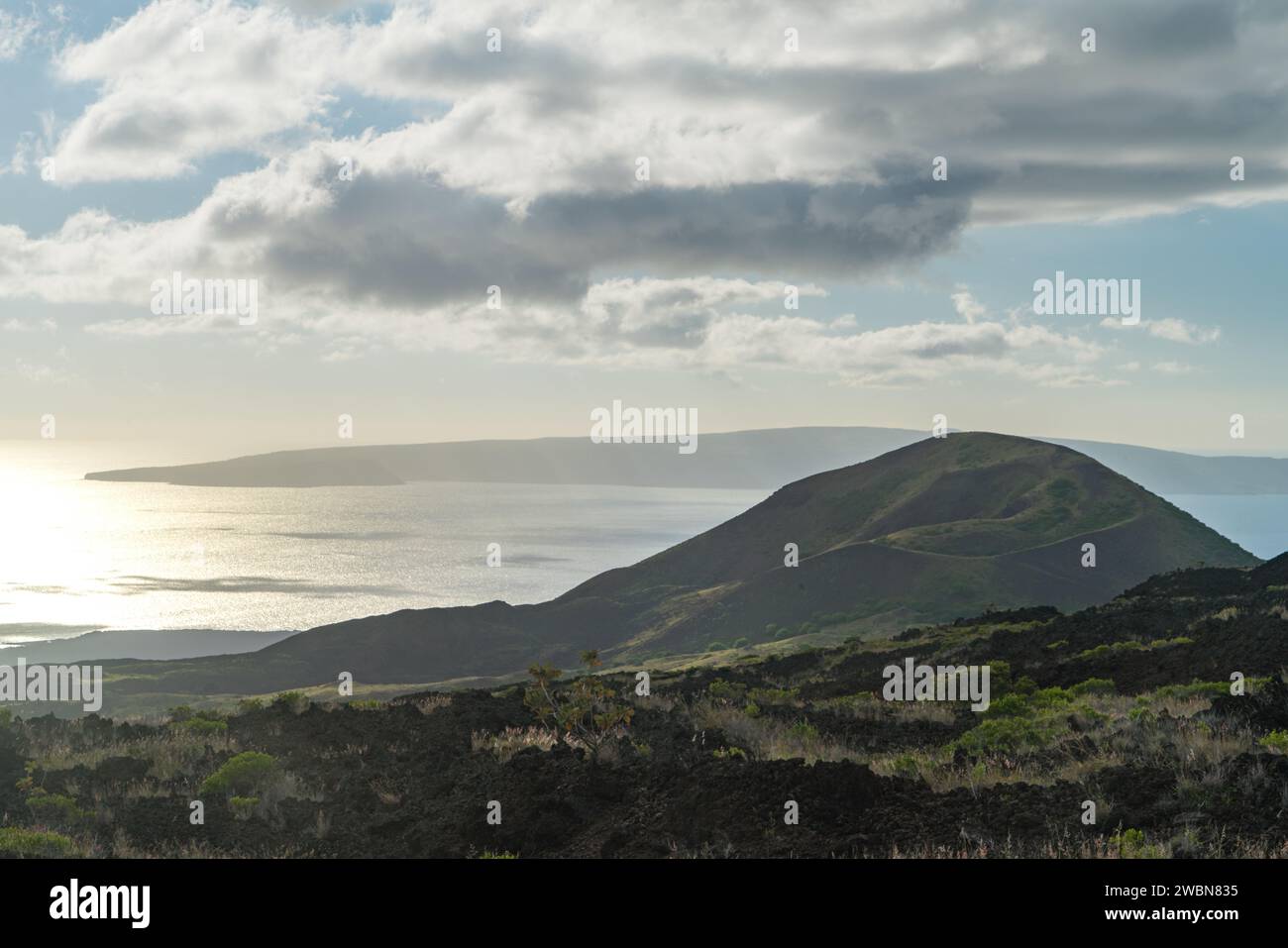 The tranquil hills of Maui bask in the glow of a setting sun, offering ...