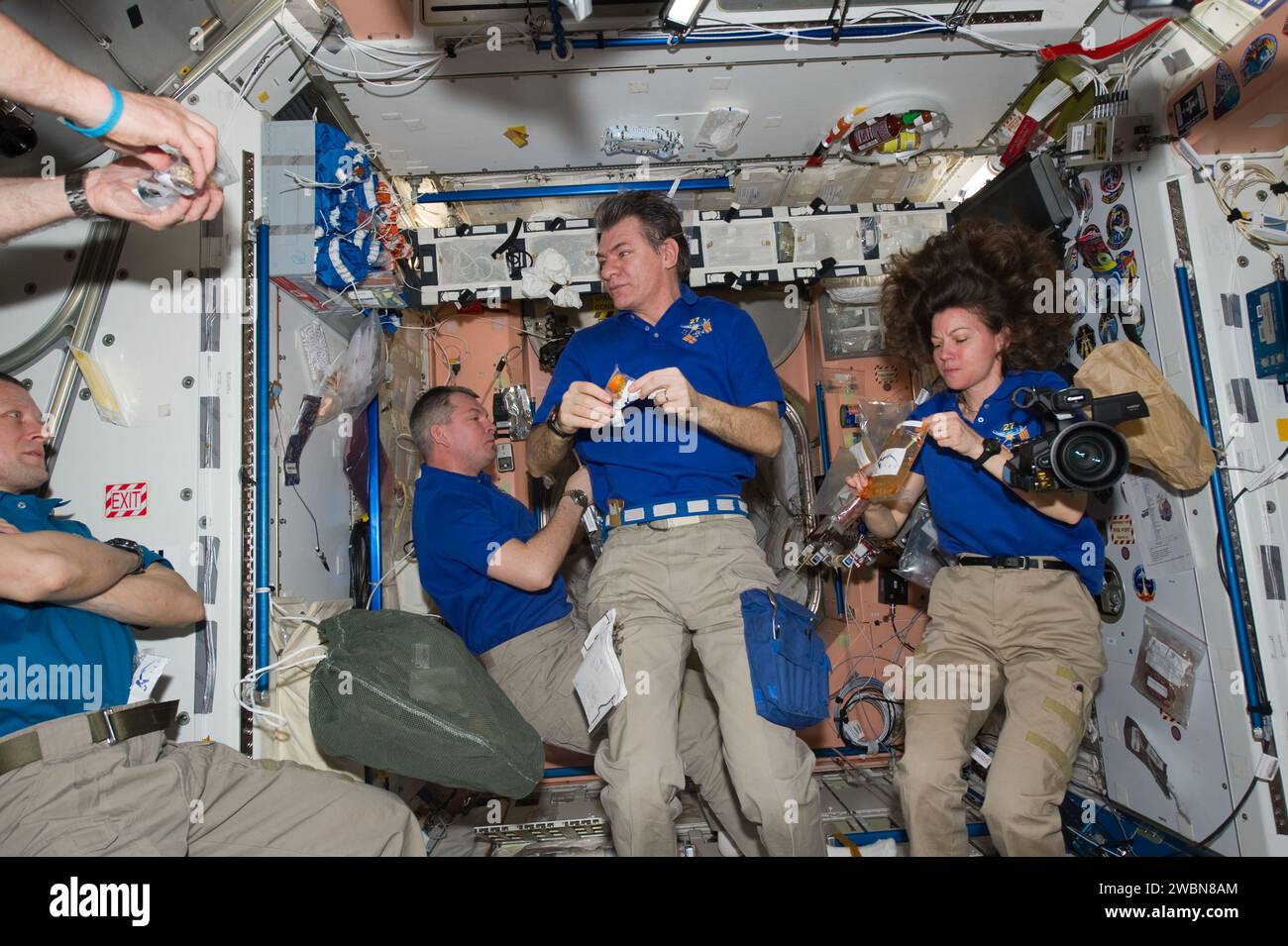 S134-E-008332(21 May 2011) --- A cosmonaut and two astronauts ...