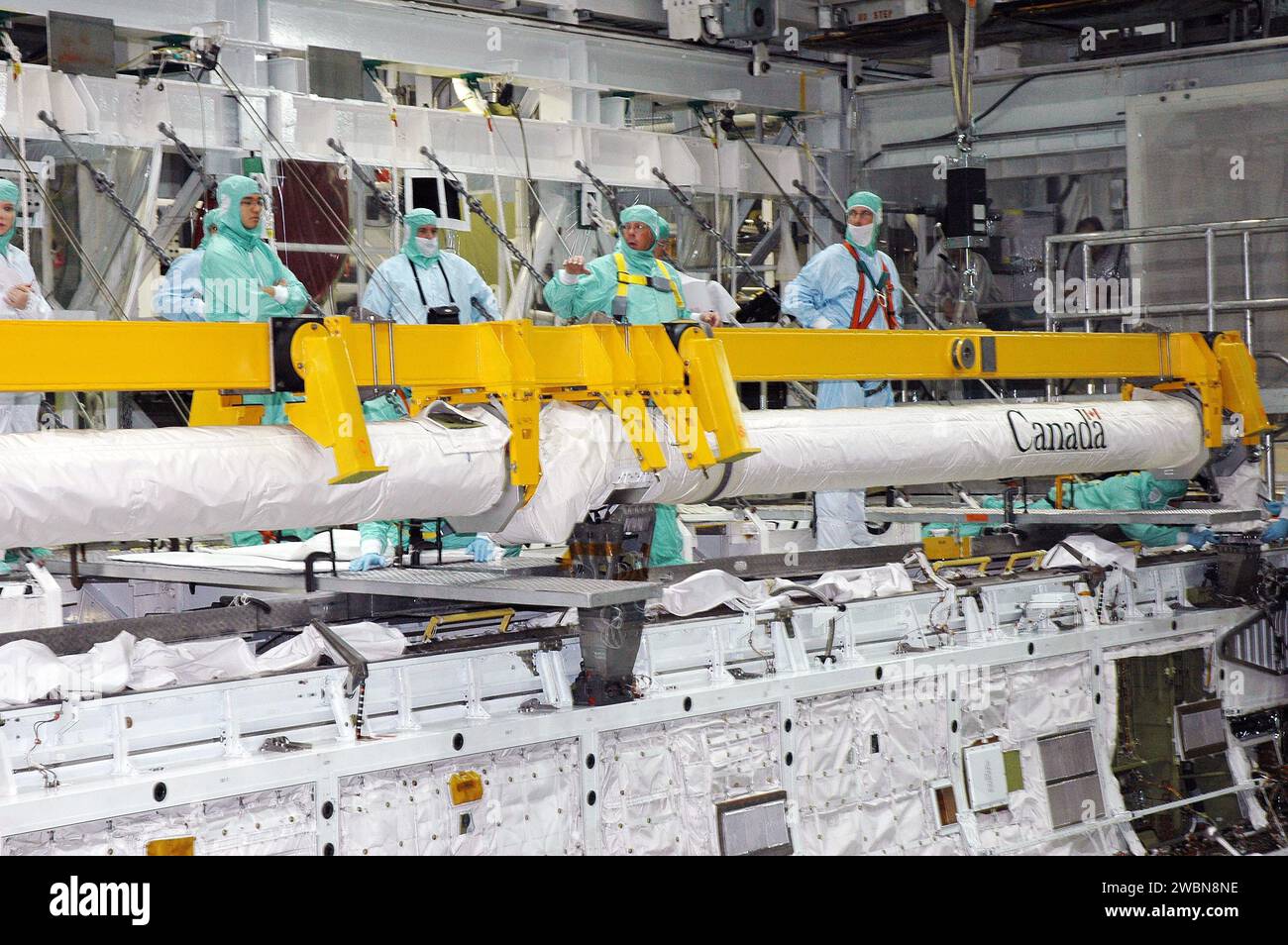 Engineers in the Orbiter Processing Facility prepare to install the ...