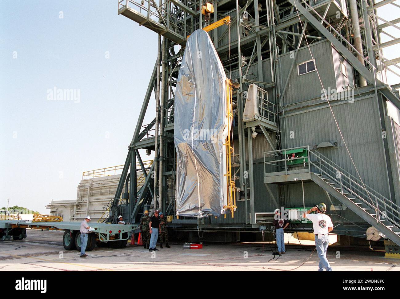 The second part of the fairing for Genesis is lifted at Launch Complex ...