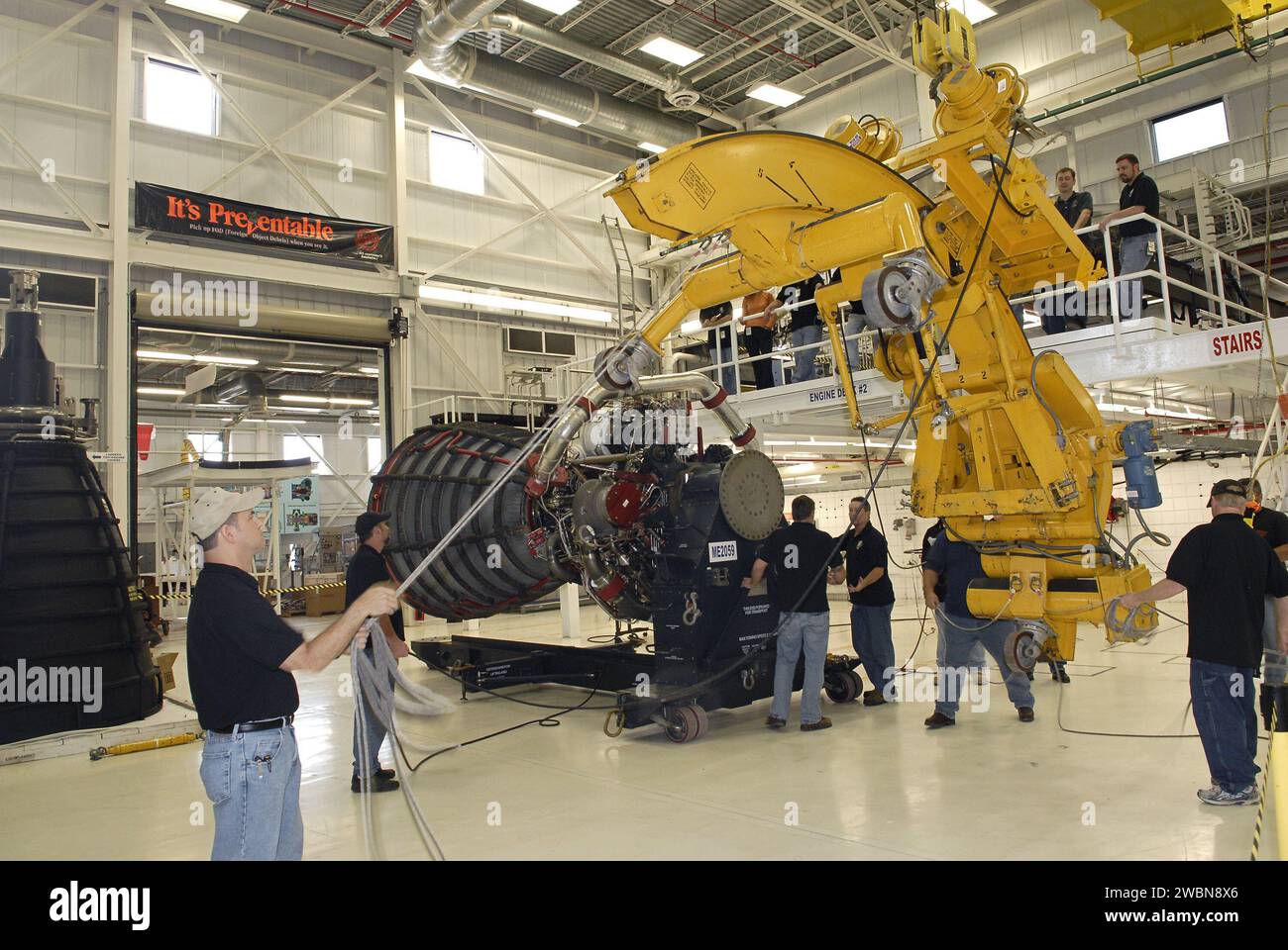 CAPE CANAVERAL, Fla. – A crane moves the engine-handling device away from the Pratt and Whitney ...