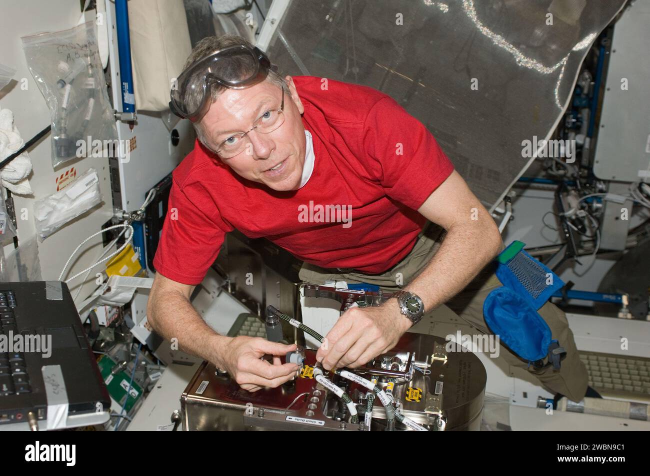 NASA astronaut Mike Fossum, Expedition 29 commander, operates the Water ...