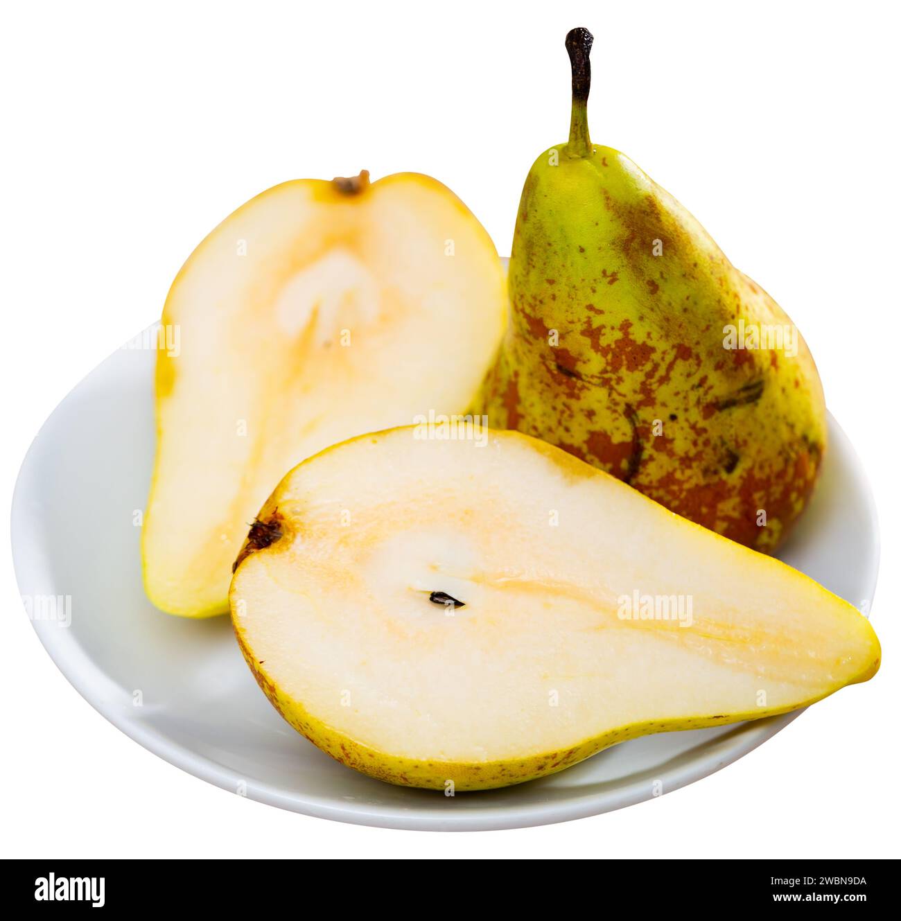 Juicy ripe pears, whole fruits and cut in half are on plate Stock Photo ...