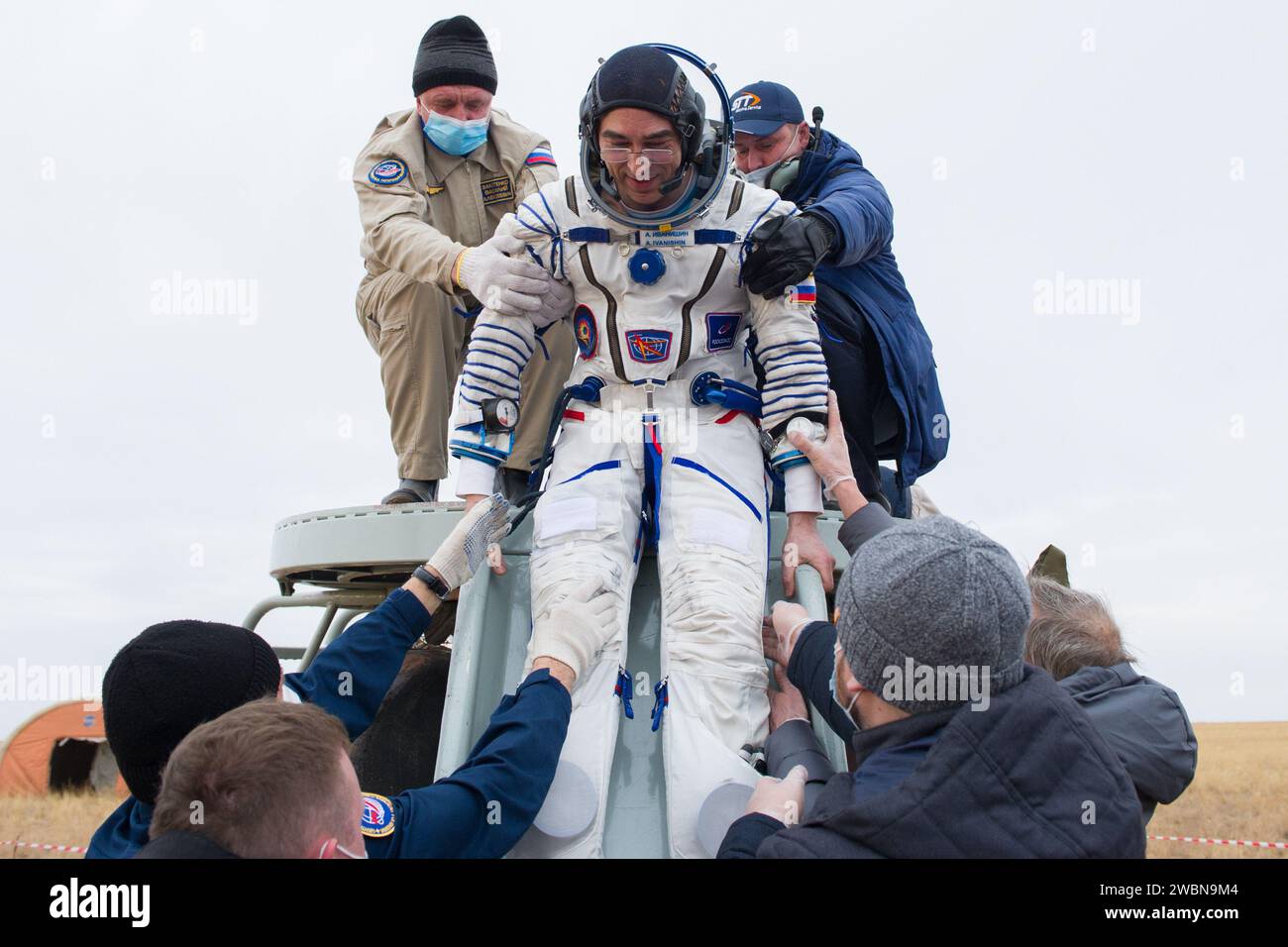 Expedition 63 Roscosmos cosmonaut Anatoly Ivanishin is helped out of ...