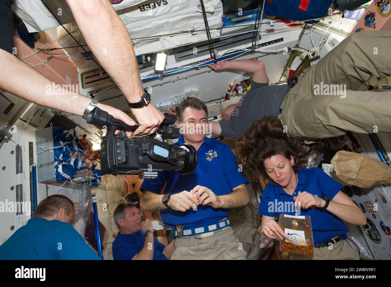 S134-E-008332(21 May 2011) --- A cosmonaut and two astronauts ...